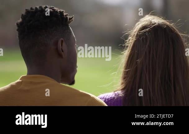 Young interracial kissing, back of two people kiss Stock Video Footage ...