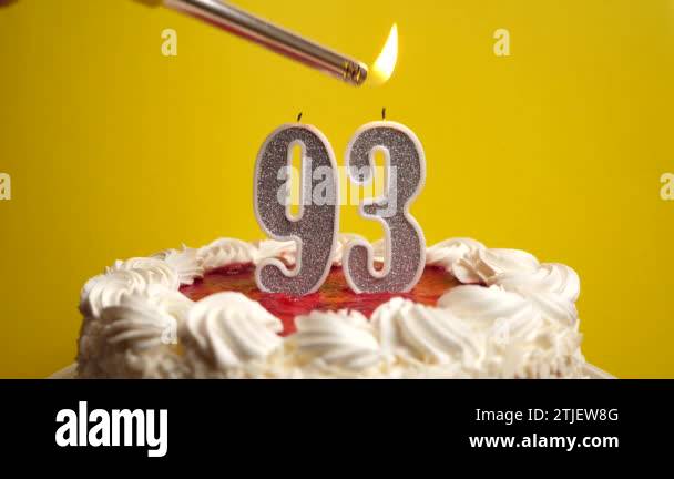 A candle in the form of the number 93, inserted into the holiday cake ...