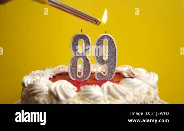 A candle in the form of the number 89, inserted into the holiday cake ...