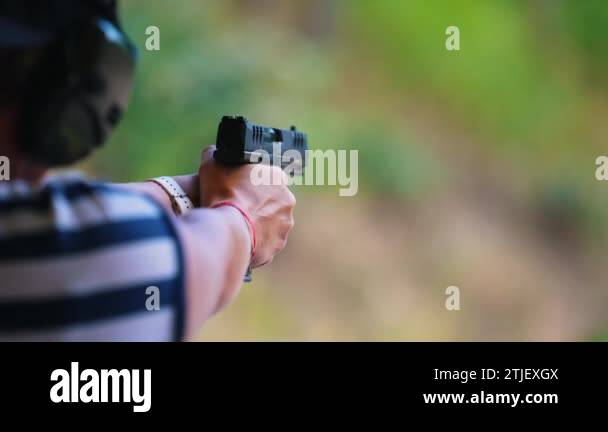 Outdoor shooting range concept. Back view of an unrecognizable ...