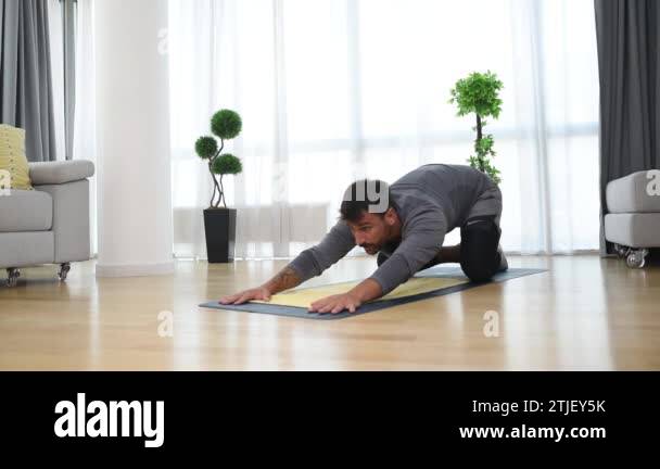 Young man cancer survivor practicing home workout yoga training ...