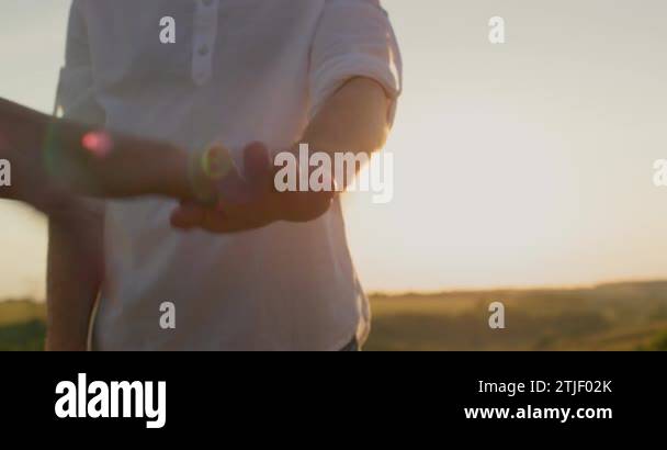 A group of people put their palms on top of one another and raise them ...