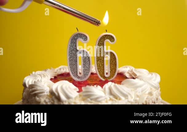 A candle in the form of the number 66, inserted into the holiday cake ...