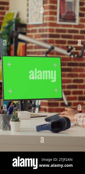 Vertical video: African american man analyzing greenscreen display on ...