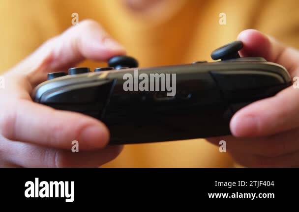 Woman hands holding black joystick gamepad playing game console ...