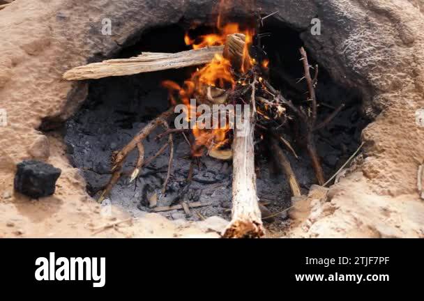 A traditional clay oven with wood fire at a nomads' hut in the Sahara ...