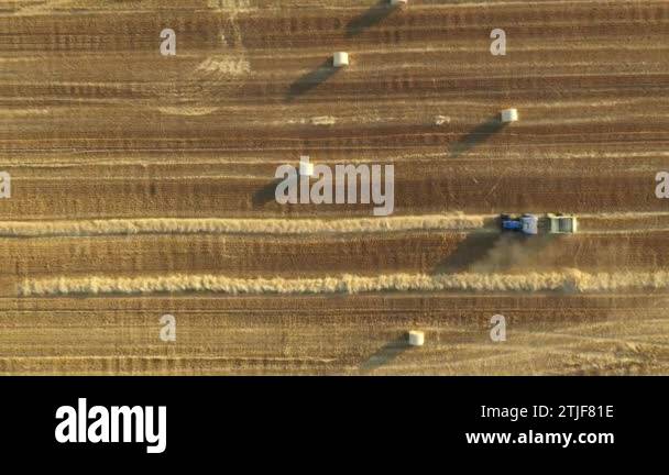 Above top view, dolly move upwards, on tractor as pulling round baler ...