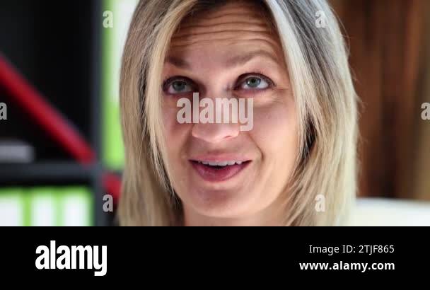 A smiling woman rolls her eyes, a close-up face. Facial expressions and ...