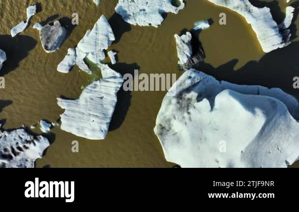 Large Chunks of Ice Float in Brown Glacier Lagoon in Iceland Global ...