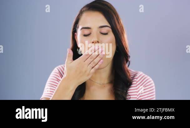 Face, yawn and tired woman in studio with fatigue, problem and ...