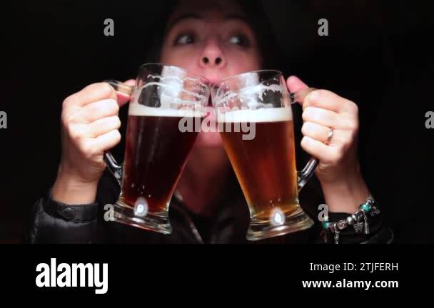 Woman acting silly celebrating with craft beers toasting herself ...