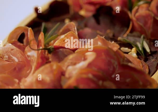 meat appetizer. food serving process. prosciutto ham and jamon cut on ...