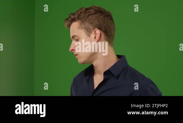 Close-up portrait of single white man looking down serious on green ...