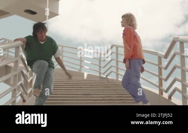 Full length slowmo of young gen z multiethnic couple in colorful y2k ...