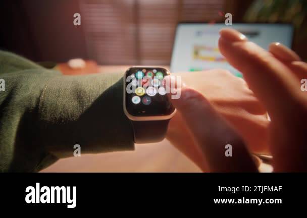 Concept of business, technology and busy people. Close up of female hands setting smart watch ...