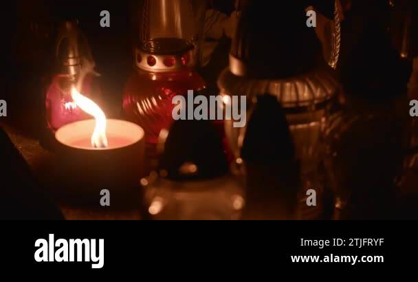 Cemetery grave candle lanterns illuminated by night. All Saints' Day ...
