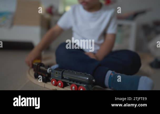little boy playing with toy train in traditional wooden tracks. Child ...