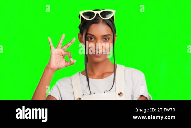 Ok hand, happy and face of Indian woman on green screen for agreement ...