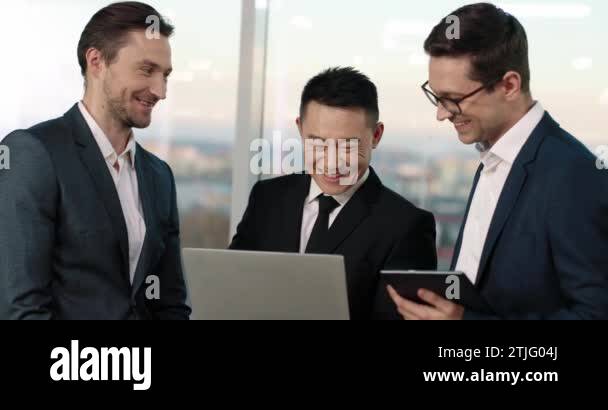 Sucessfull mixed-race managers having fun time during work. People with ...