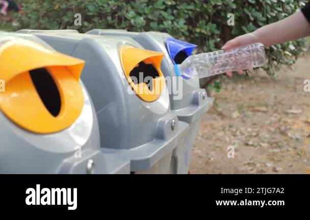 Close up hand throwing empty plastic bottle into the trash recycle for ...