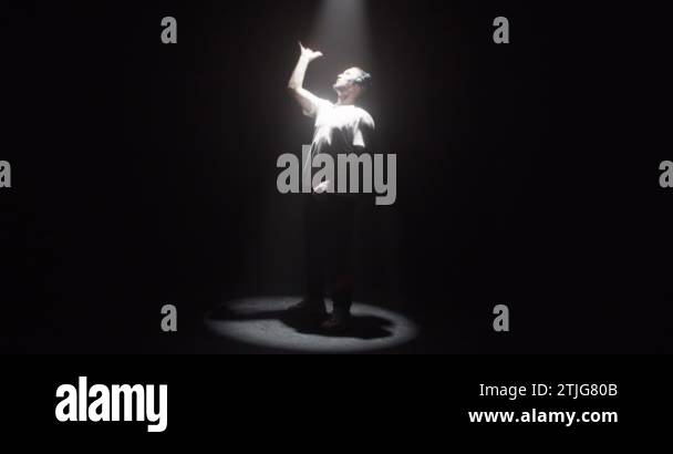 Full body of modern Caucasian guy in headphones listening to music ...