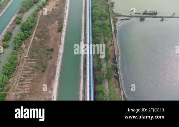 Coal duct to steam power plant company surrounded by fish ponds sea bay ...