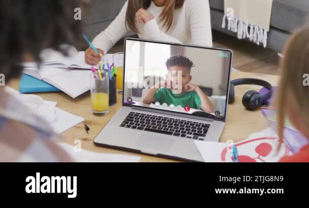 Diverse students using laptop for video call with biracial schoolboy on ...