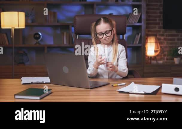 Adorable preteen girl having online conversation on remote computer ...