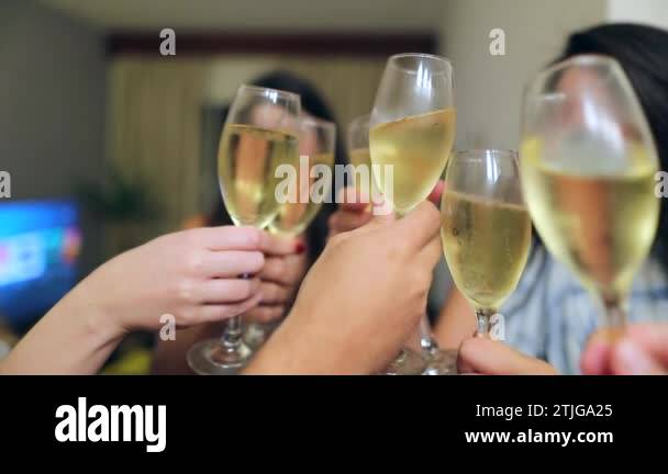 Friends cheering with champagne glasses. Candid authentic real life ...