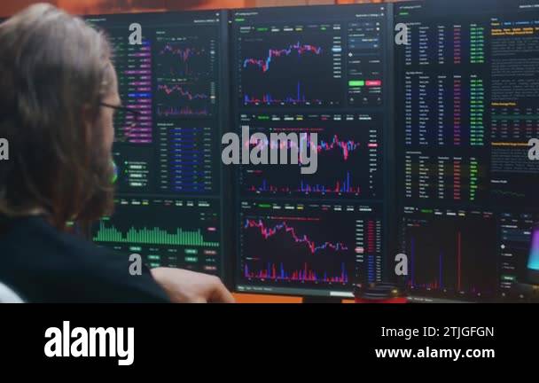 Male stock trader analyzes real-time stocks, exchange market charts on ...