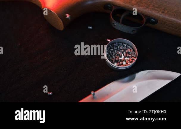 Rifle air gun with air pellets for hunting on cloth dark background ...