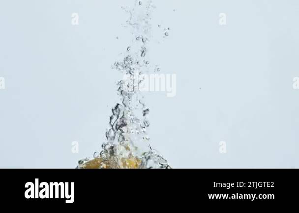 Lemon fruit falling water in bubbles closeup. Summer fresh citrus ...