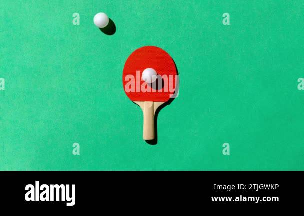 A red ping pong table tennis racket on a green table and the movement ...