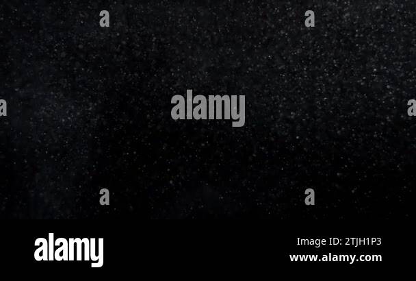 Vertical dust particles system floating on Black Screen Overlay. RED camera footage in slow ...