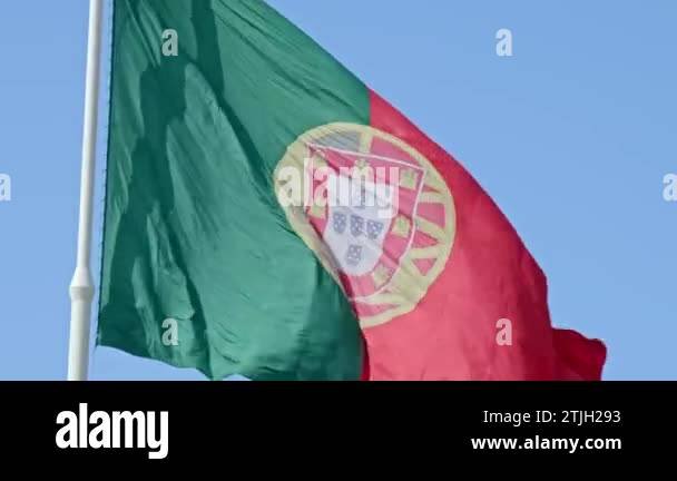 Close view of big national flag of Portugal waving in the wind from ...