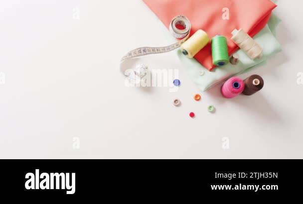 Video of folded fabric with tape measure and cotton reels on white ...