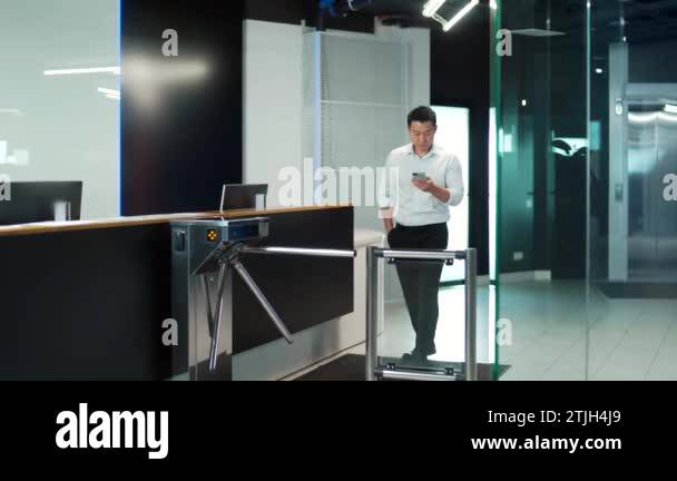 Man worker walks through a Automatic security turnstile station in ...