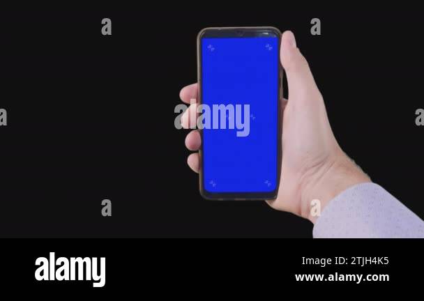 Male hand holding a smartphone with a blue screen with markers on alpha ...