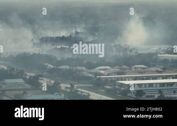Emergency service firetrucks extinguishing wildfire burning in Florida ...