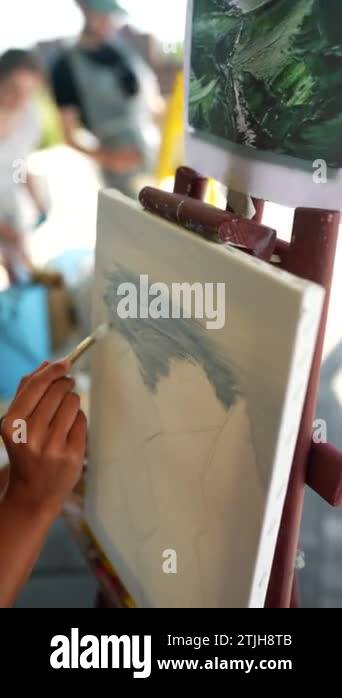 Beautiful woman artist drawing her picture on canvas with oil colors in ...