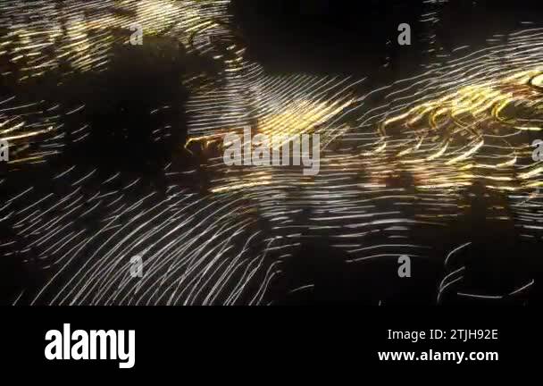 Deformed wavy wires with motion glowing elements at black background ...