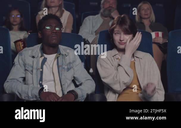 Young gen Z Black man and his Caucasian female friend watching sad ...