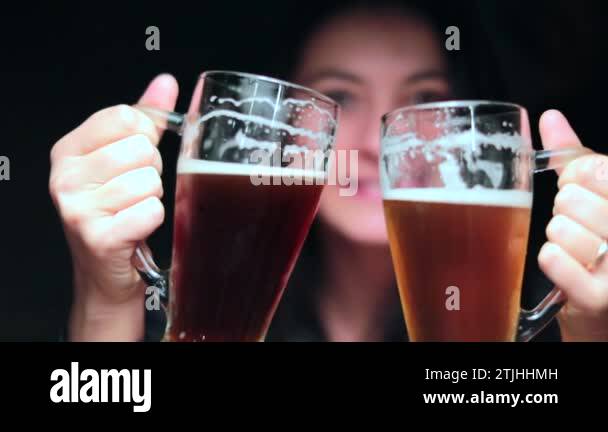 Woman acting silly celebrating with craft beers toasting herself ...