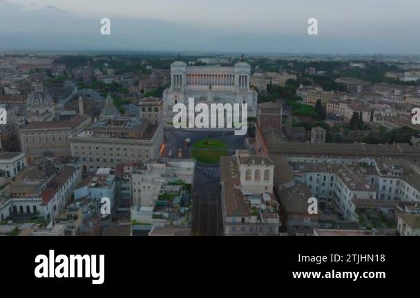 Buildings in city illuminated by rising sun. Zoomed slide and pan ...