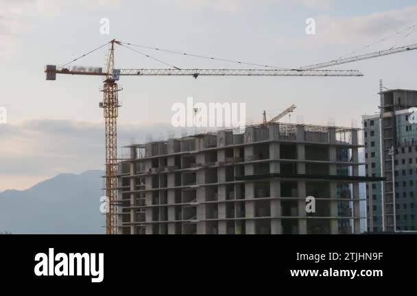 Building Construction. Tower Crane on a Construction Site Lifts a Load ...