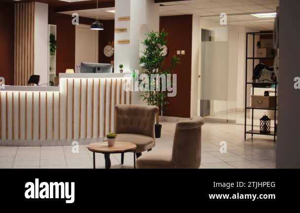 Empty stylish modern hotel lounge interior with cozy furniture and warm ...