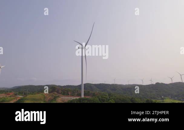 A wind farm showing multiple wind turbines at work producing wind ...