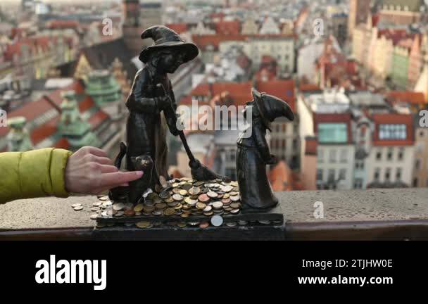 Tourist hand put coins and touch famous dwarf gnome sculpture for lucky ...
