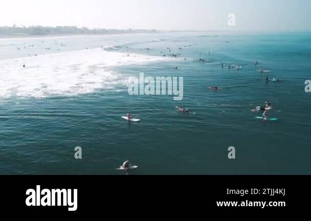 Crowd surfing, Bali. People surf the wave on famous Batu Bolong surfing ...