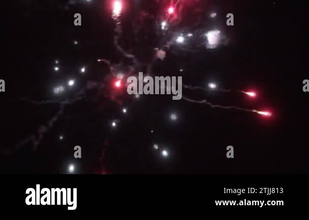 Fireworks flying into the air and exploding in front of a black night ...